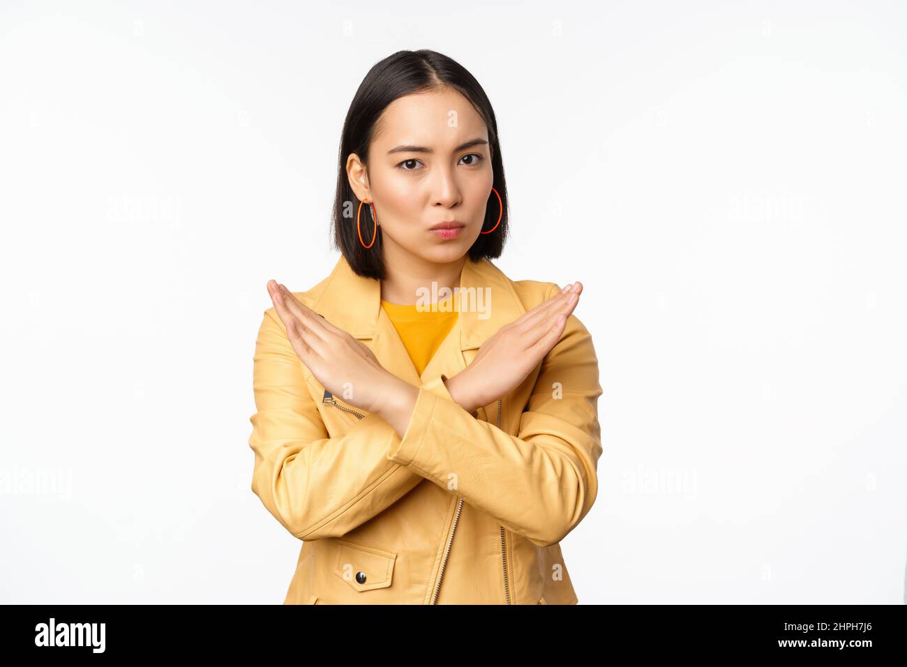 Stop gesture. Serious asian woman making arm cross, prohibit smth ...