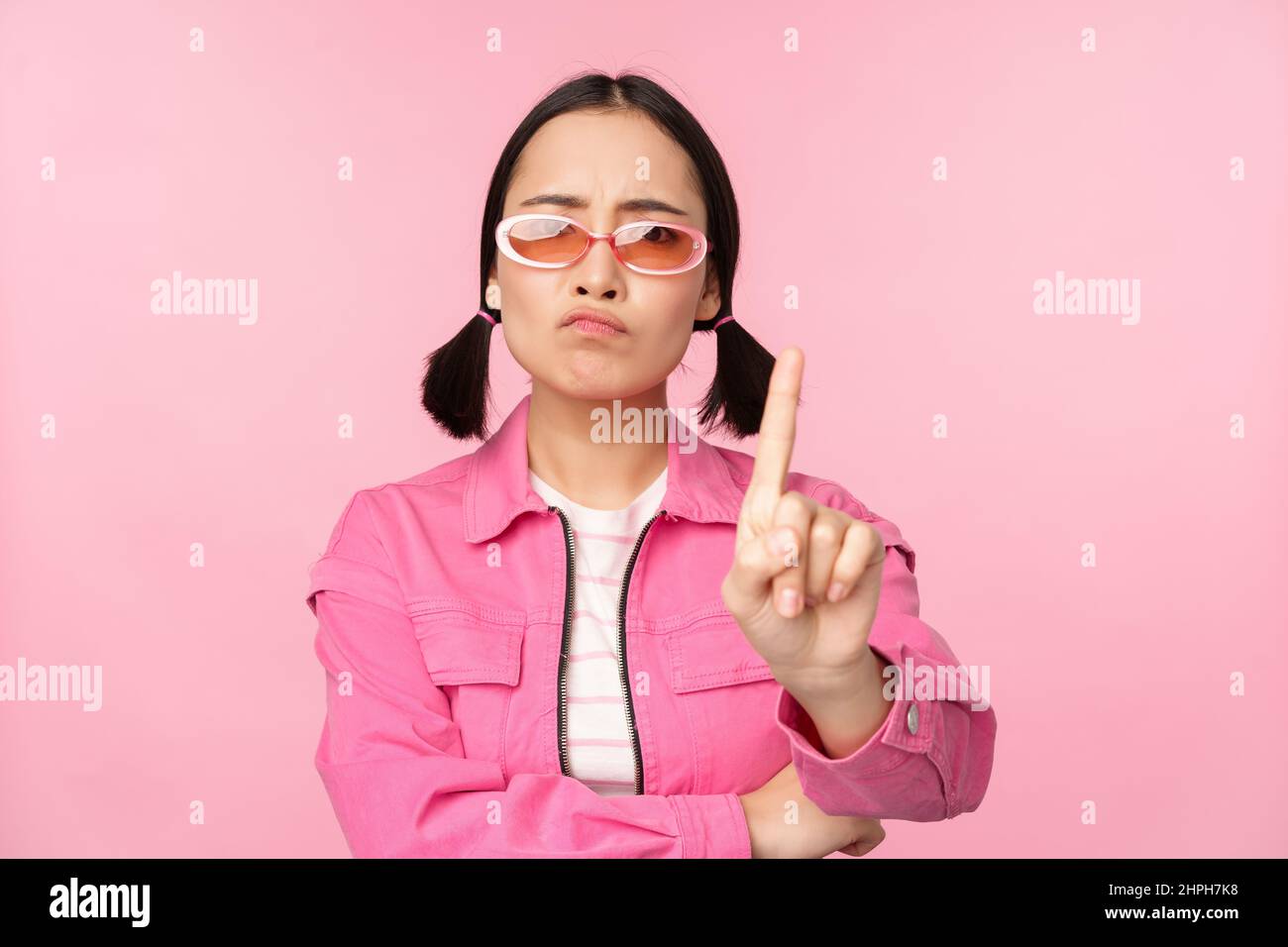 Image of serious, stylish asian girl in sunglasses, showing stop ...