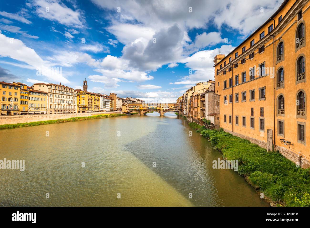 The Ponte Vecchio, famous medieval stone old bridge over the Arno River ...