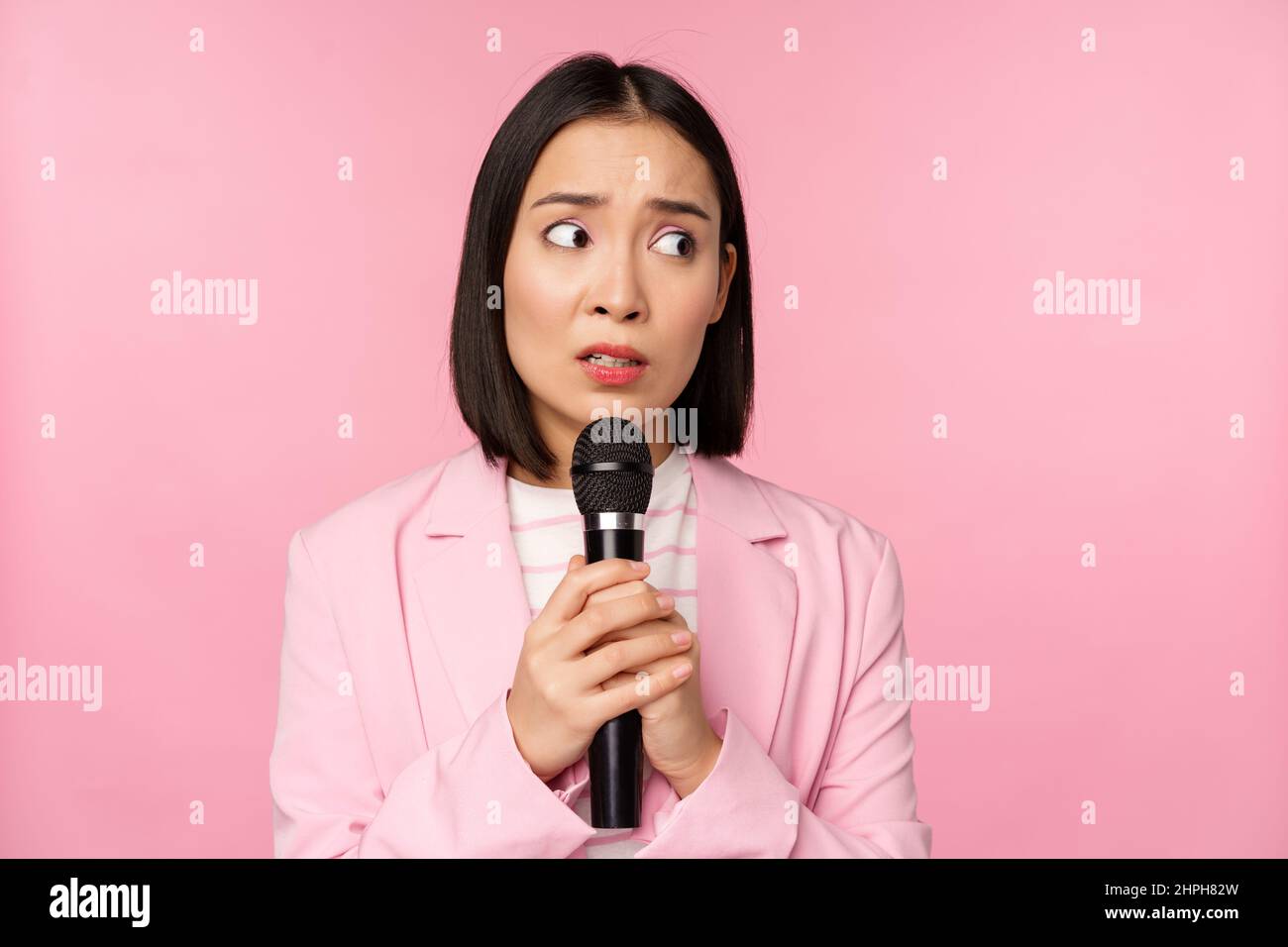 Insecure asian businesswoman giving speech, scared of talking in public ...