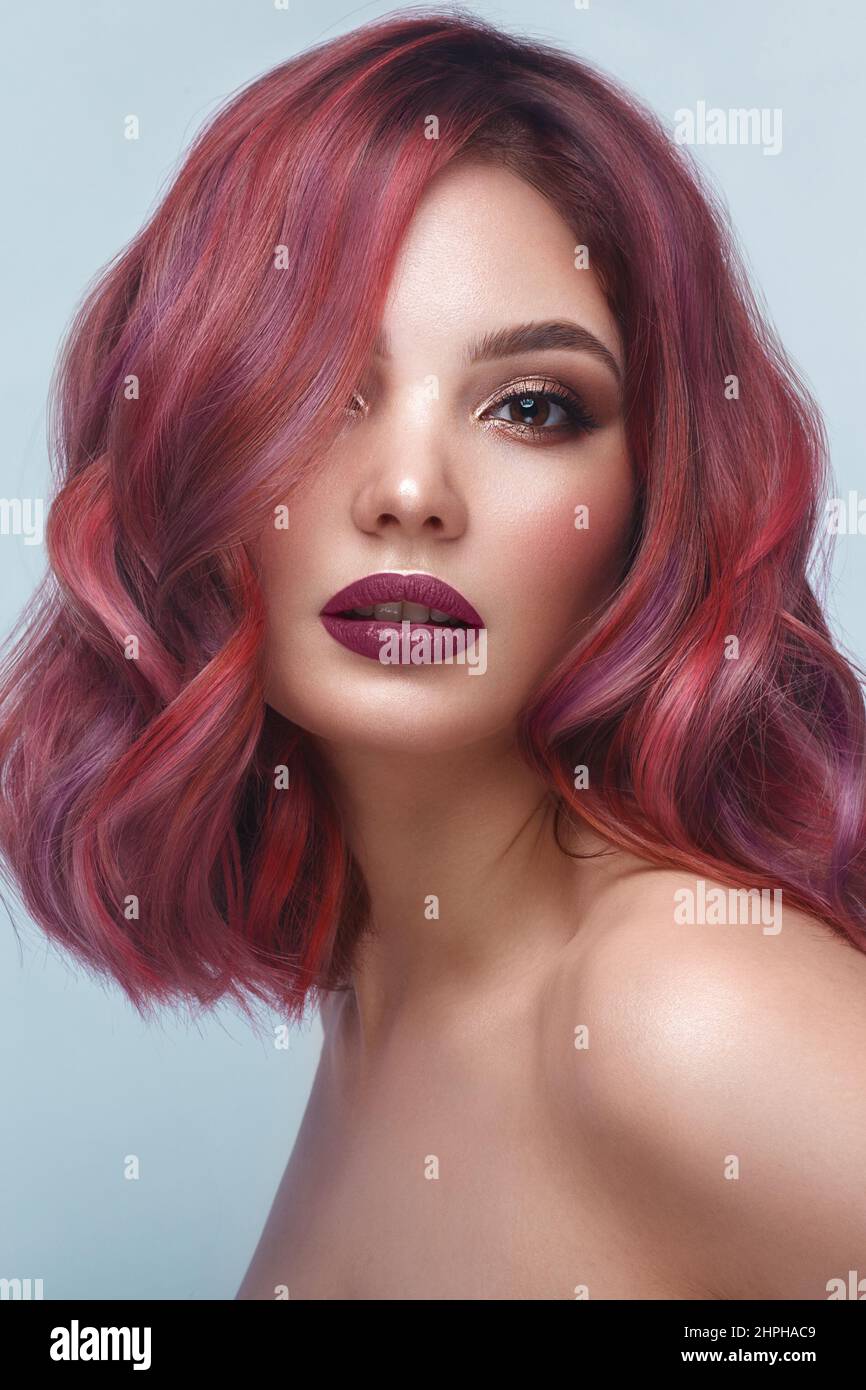 Beautiful girl with multi-colored hair and classic make-up and ...