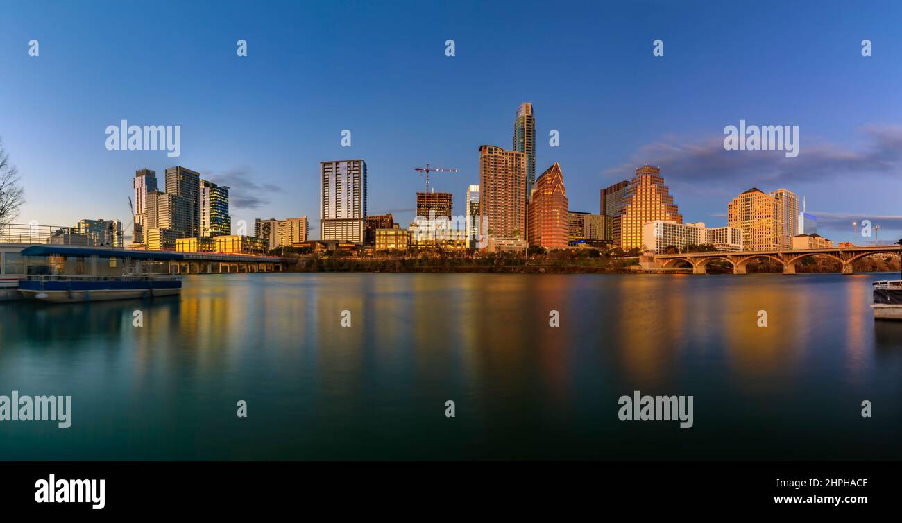 Panorama with downtown high-rises reflecting sunset golden hour light ...