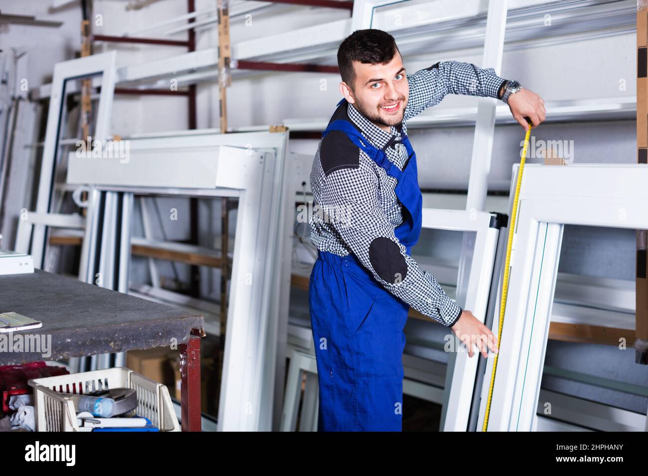 Professional friendly smiling labour with finished PVC profiles and ...