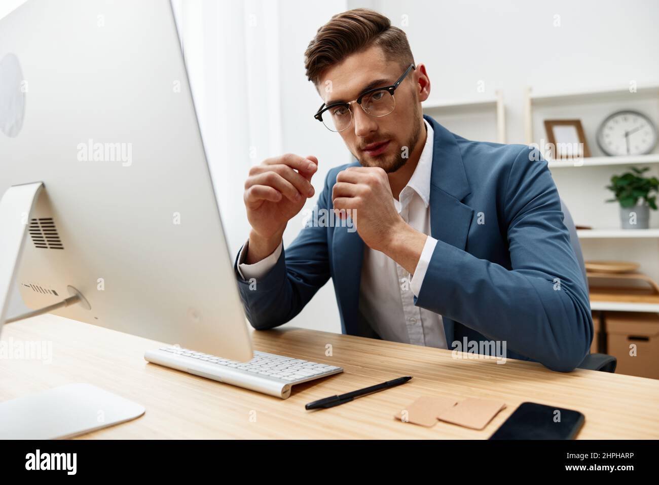 handsome businessman at the desk in the office an official executive ...