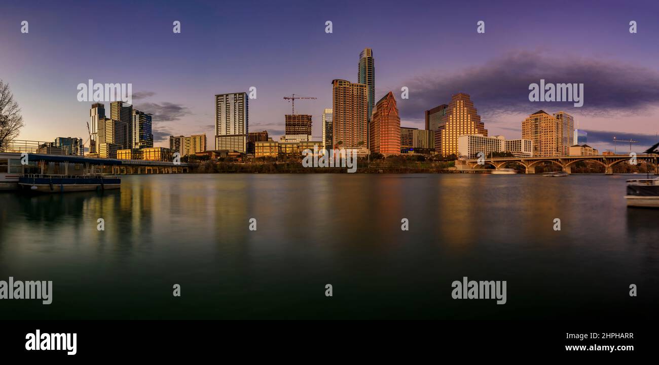 Panorama with downtown high-rises reflecting sunset golden hour light ...