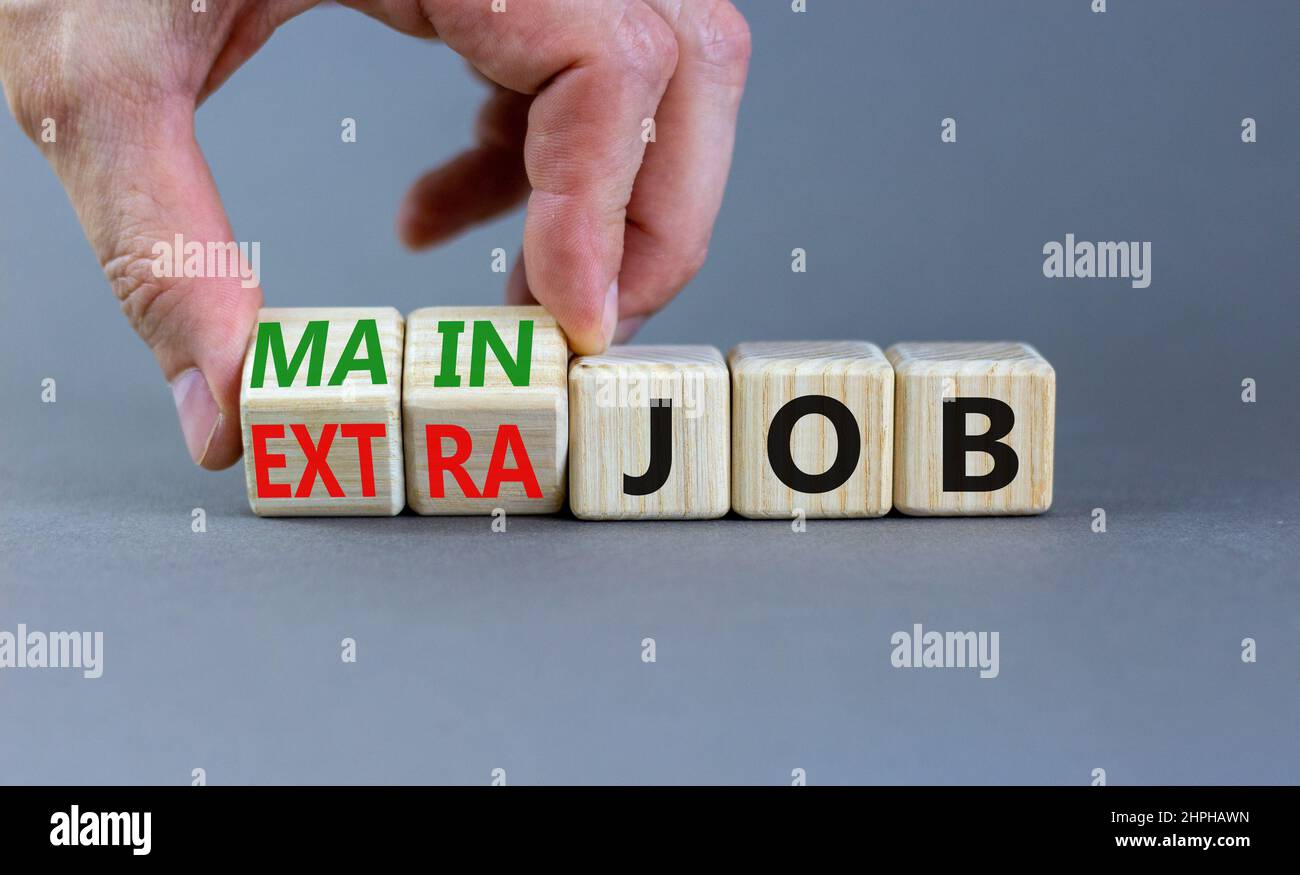 Extra or main job symbol. Businessman turns wooden cubes and changes ...
