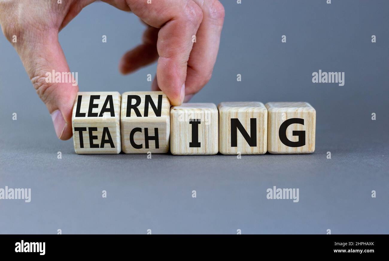 Learning or teaching symbol. Businessman turns wooden cubes and changes ...