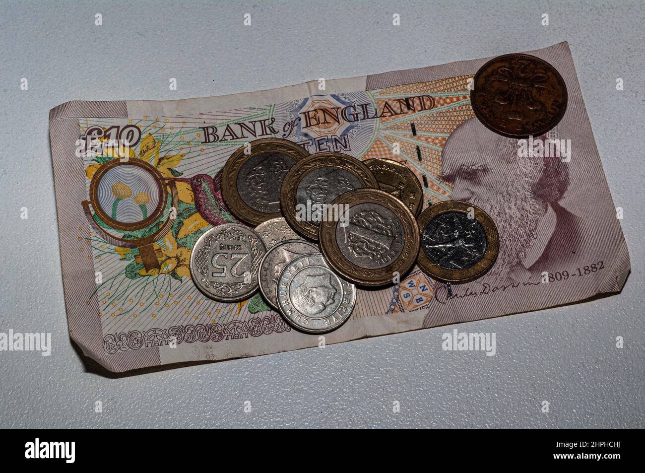 Ten pound note and assorted foreign coins Stock Photo - Alamy