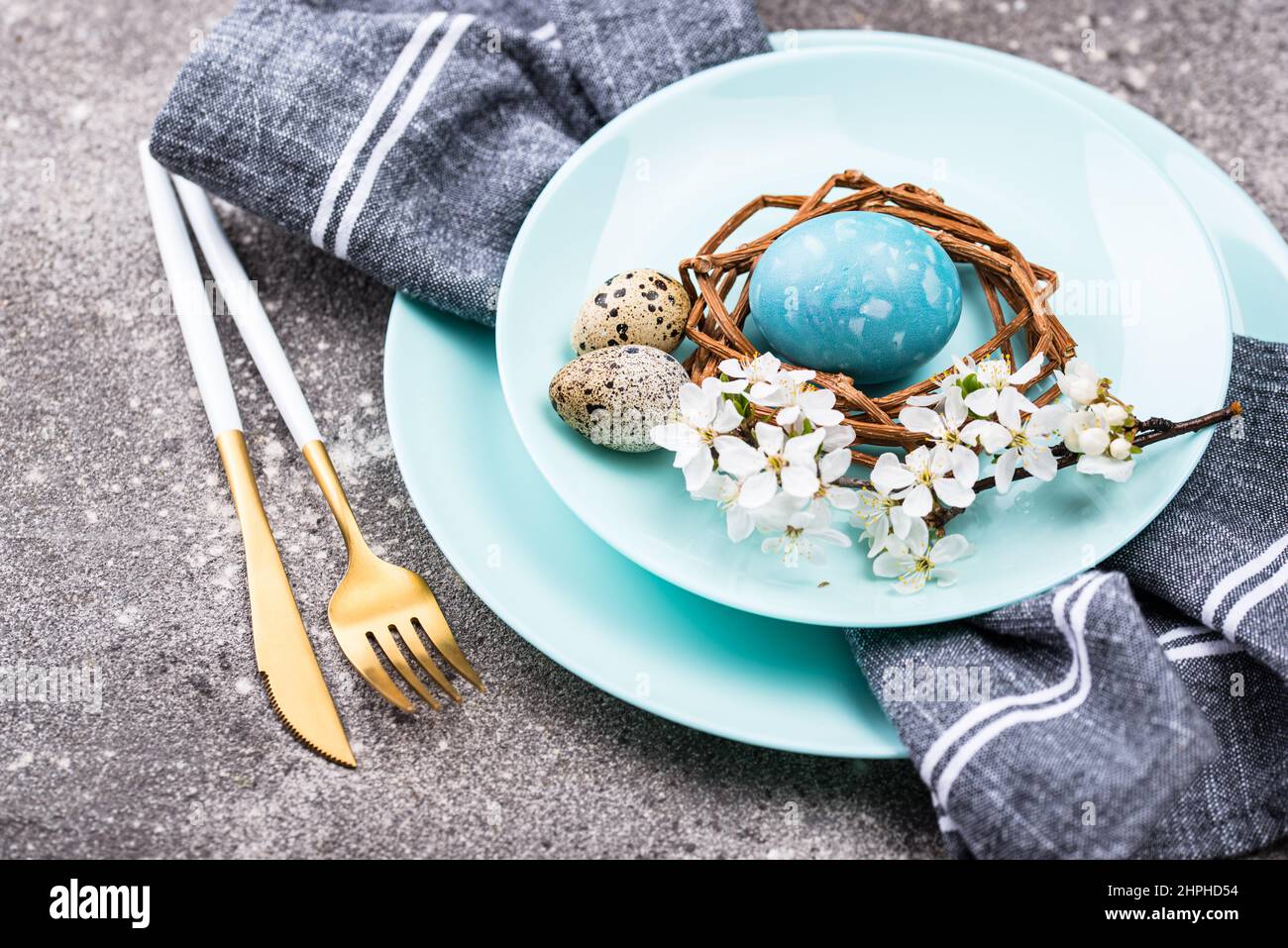 Easter table setting with blue egg Stock Photo - Alamy