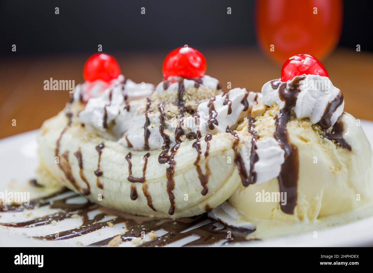 Close-up of delicious banana split dessert and raspberry beer glass ...