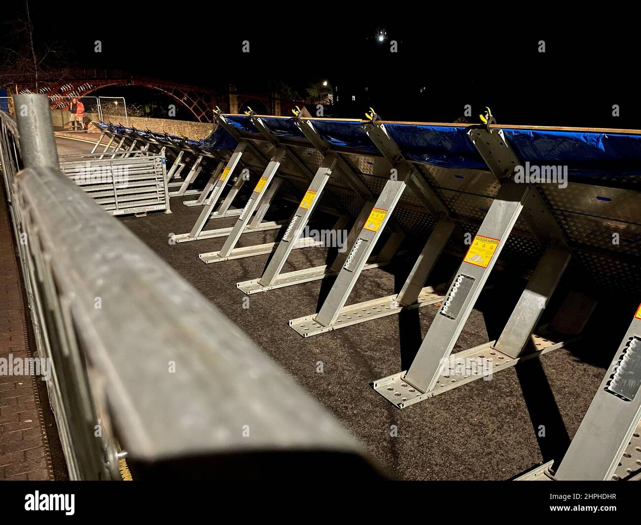 Workmen build flood defences at the River Severn in Ironbridge ...