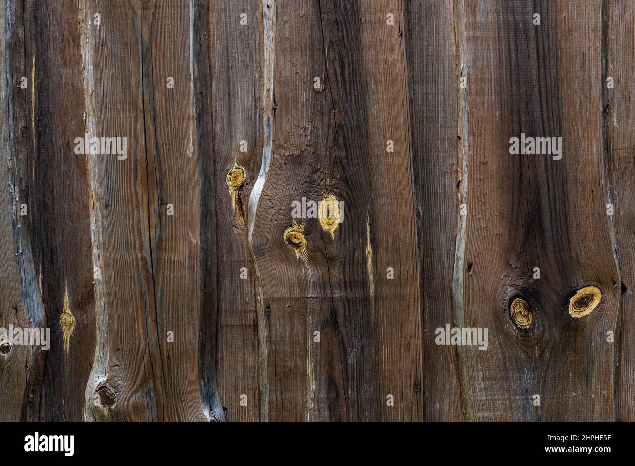 Old fence from a dark board. Boards with knots. Background screensaver ...