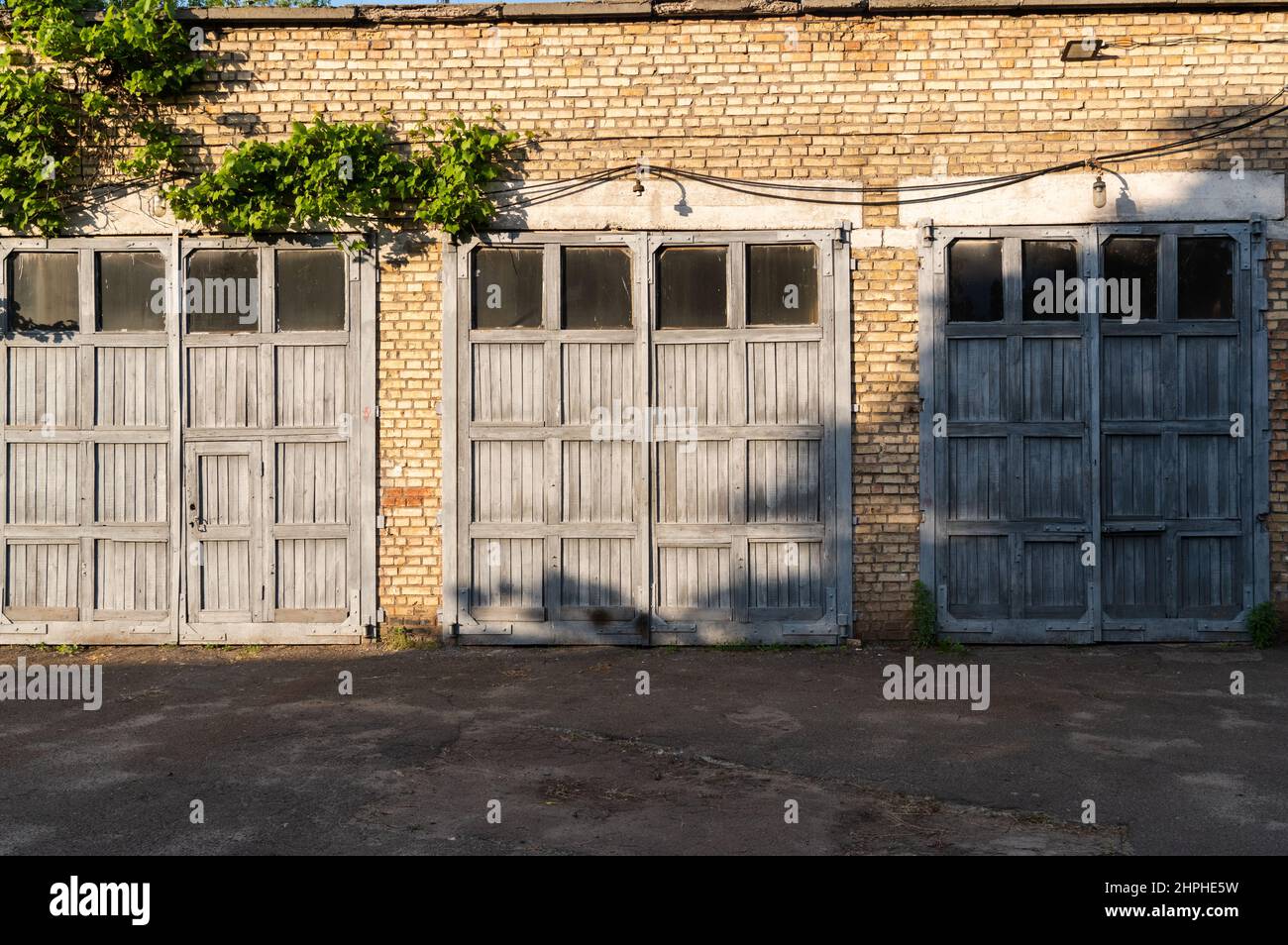 The building has a garage for several cars. Large wooden gate in the ...