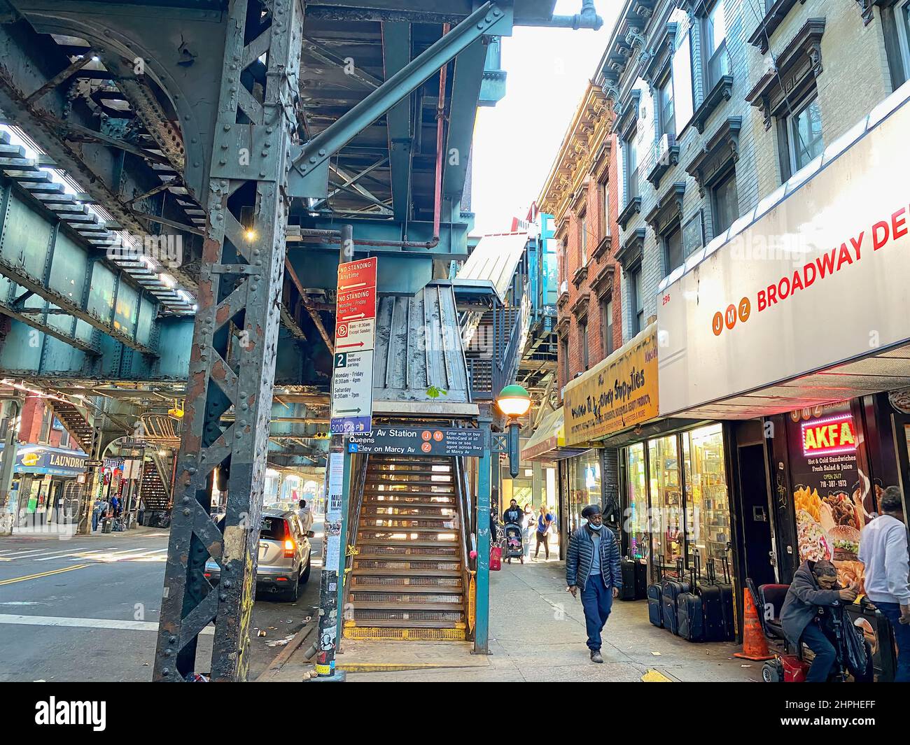 Brooklyn, NY, USA - Feb 21, 2022: Marcy Avenue shopping area under the J, M, J, subway platform ...