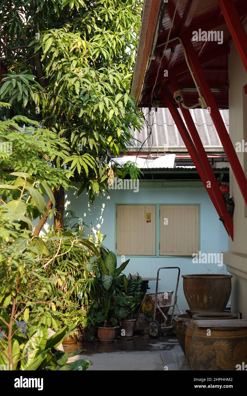 Quiet backyards of Wat Arun temple with red and white house (vertical ...