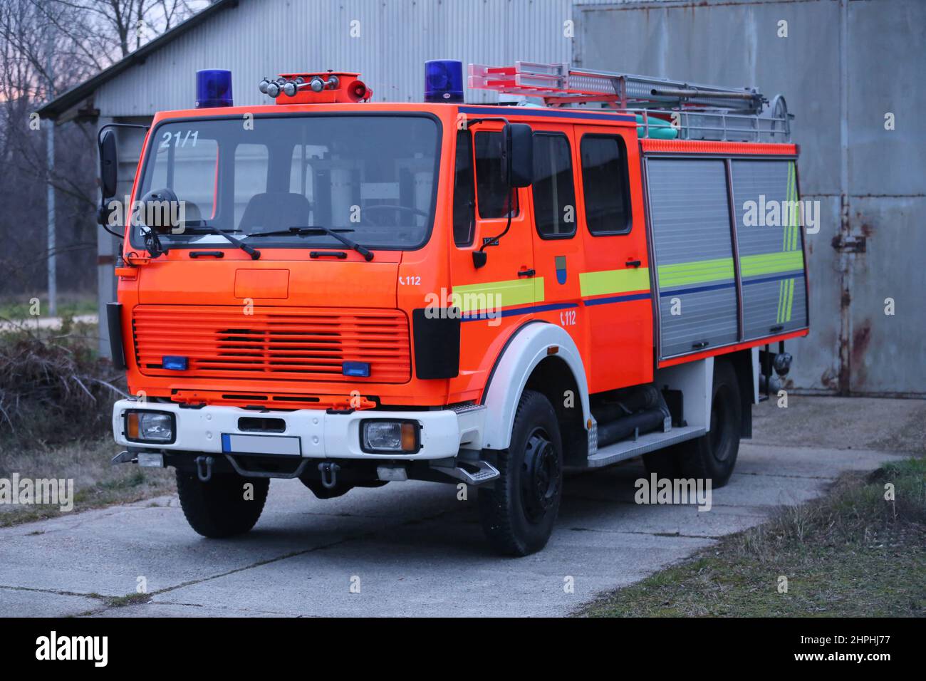 Red fire engine car parked with emergency ladder without firemen on ...