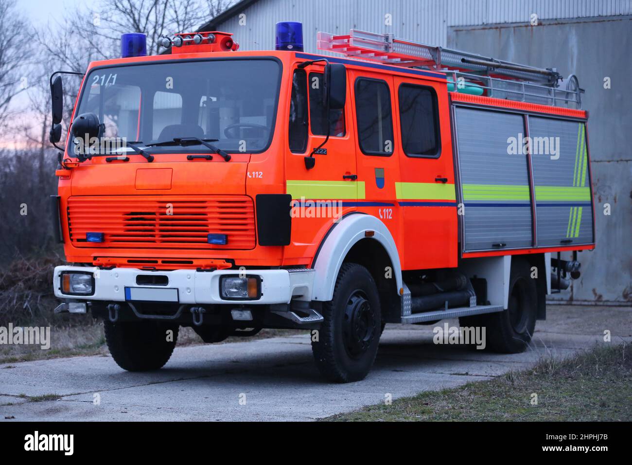 Red fire engine car parked with emergency ladder without firemen on ...