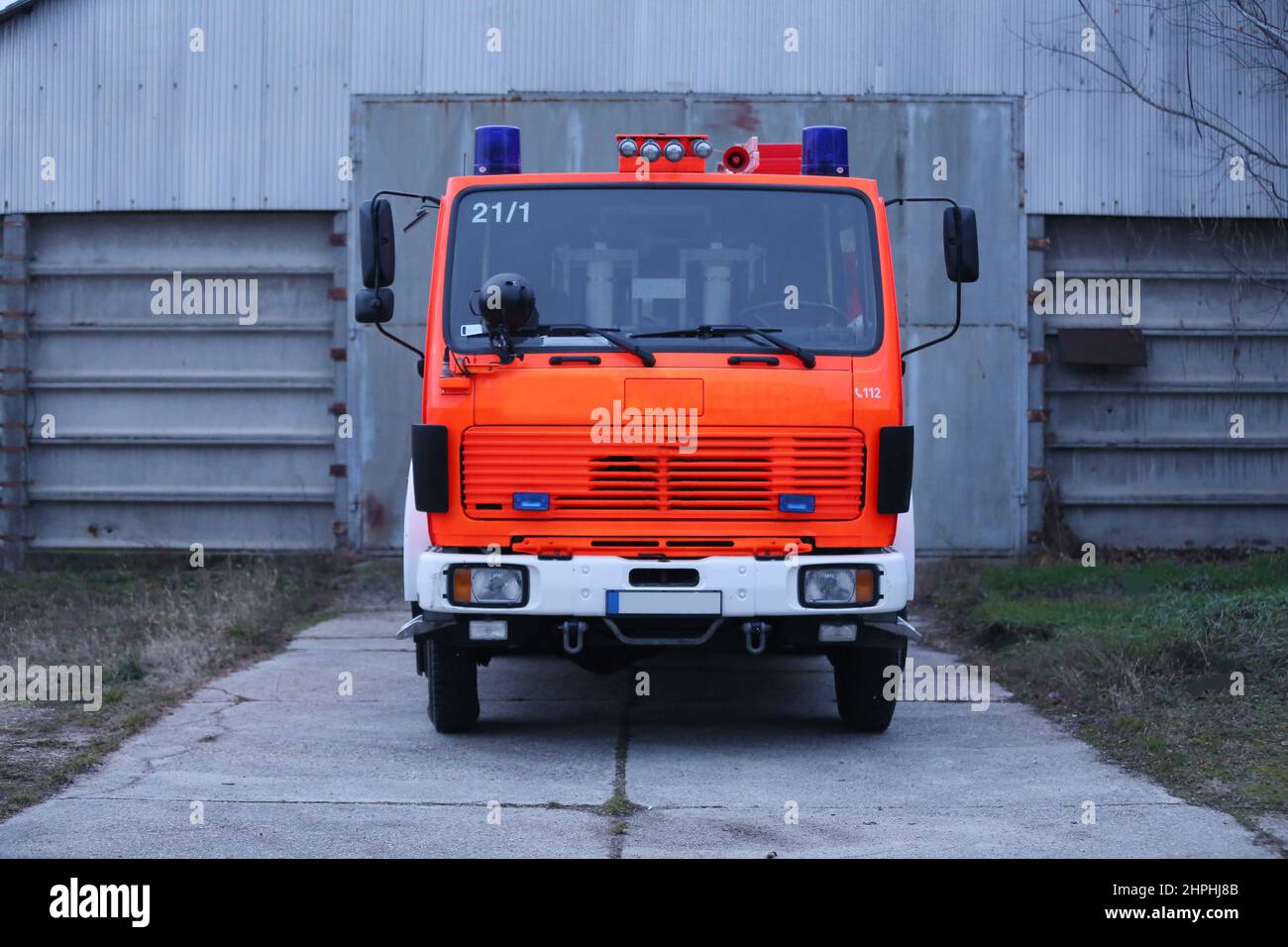 Red fire engine car parked with emergency ladder without firemen on ...