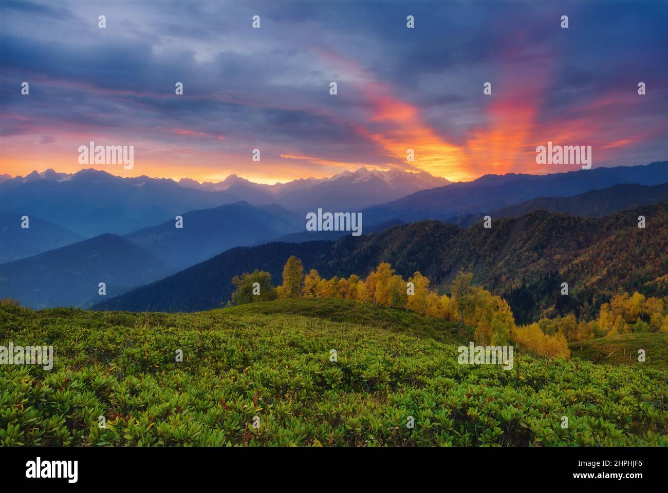 Fantastic red sunbeams with overcast sky at the foot of Mt. Ushba ...