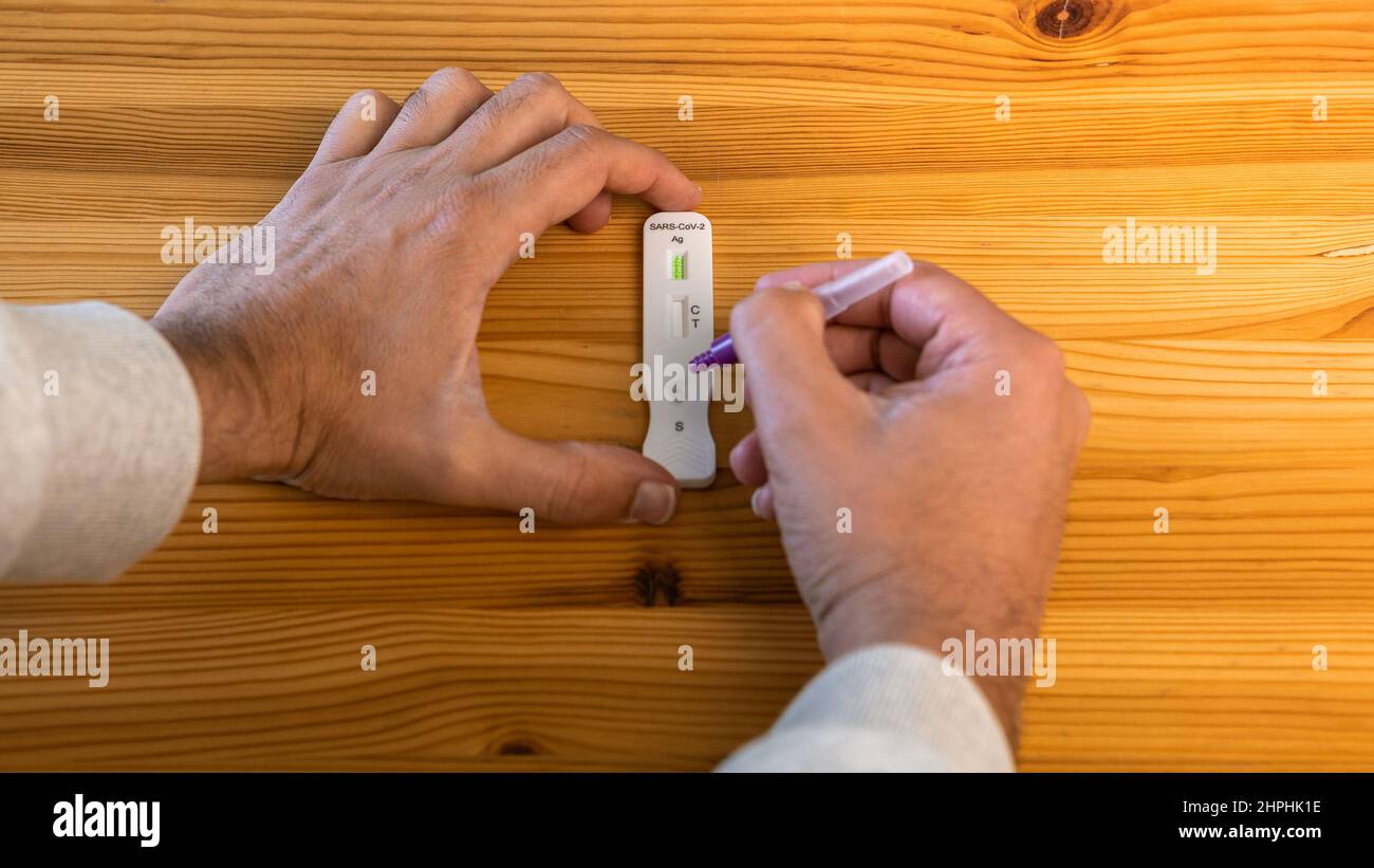 Close-up of man placing the sample into a buffer dropper for seft ...