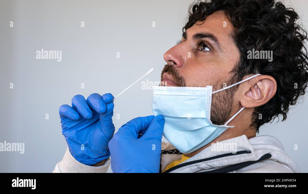 Portrait of relaxed man wearing mask and latex gloves taking a self ...