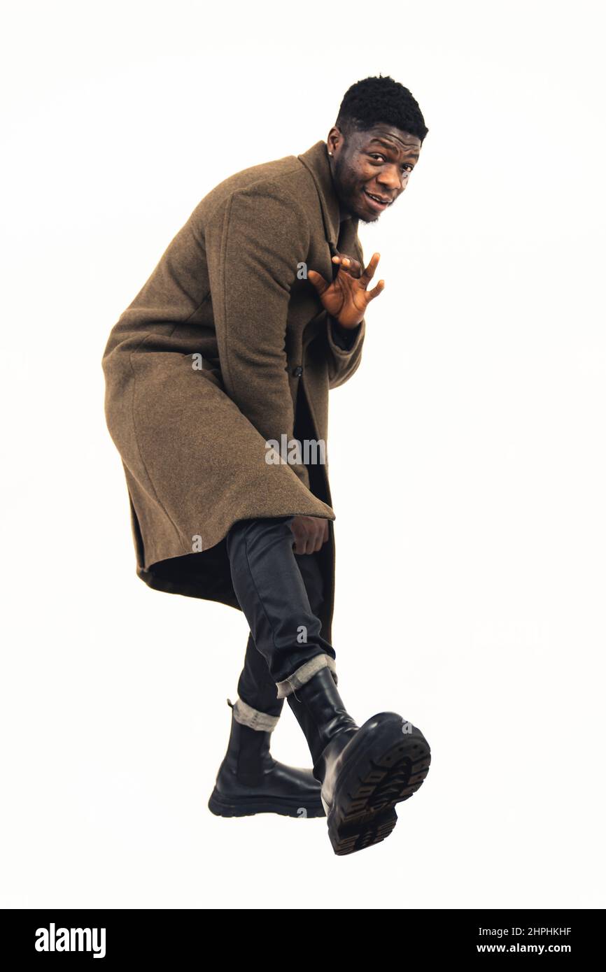 black male model pointing shoe at the camera white background - full ...