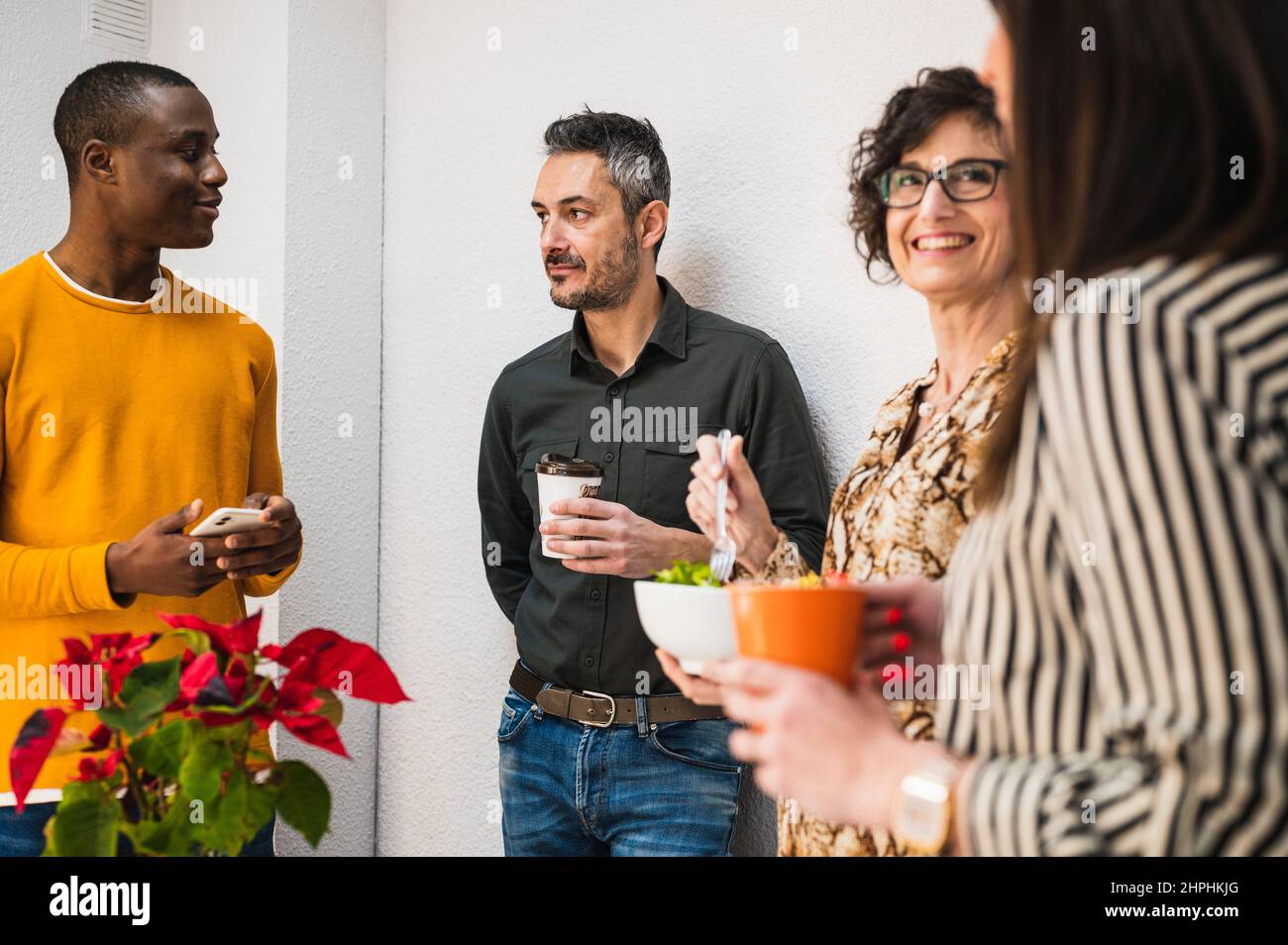 Diverse group of people taking a lunch break in an office Stock Photo ...
