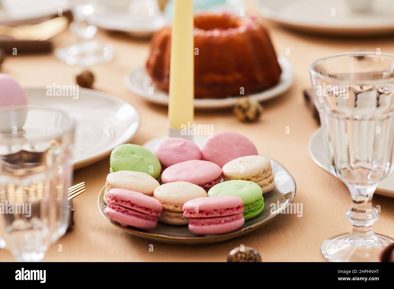Closeup of pastel macaroons platter on elegant dinner table decorated ...