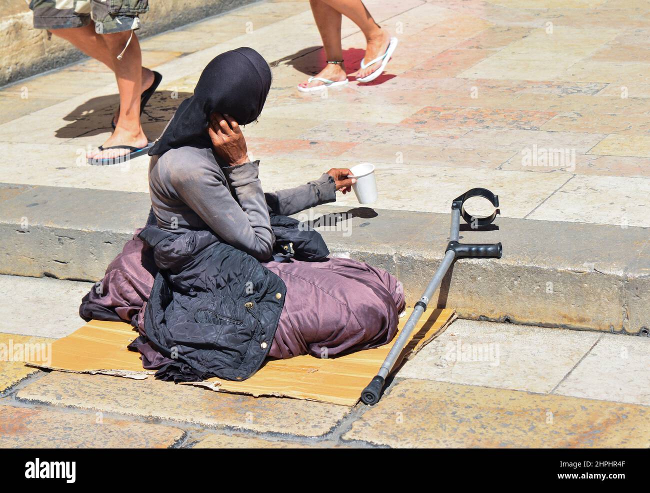 Poor woman begging in the street in Europe Stock Photo - Alamy