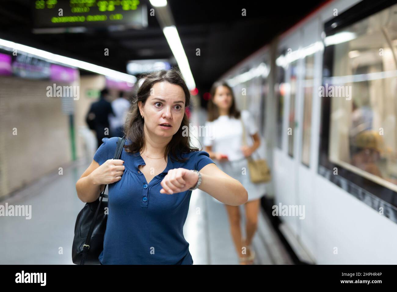 Hurrying woman is late for subway train Stock Photo - Alamy