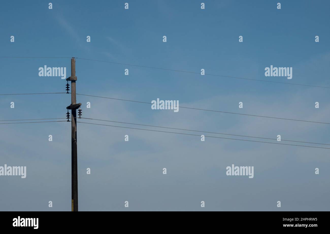 poles for power lines on the side of the road Stock Photo - Alamy