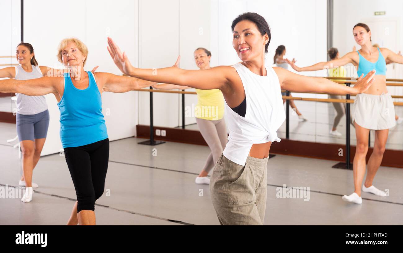 Group of active women practicing energetic dance in a studio Stock ...