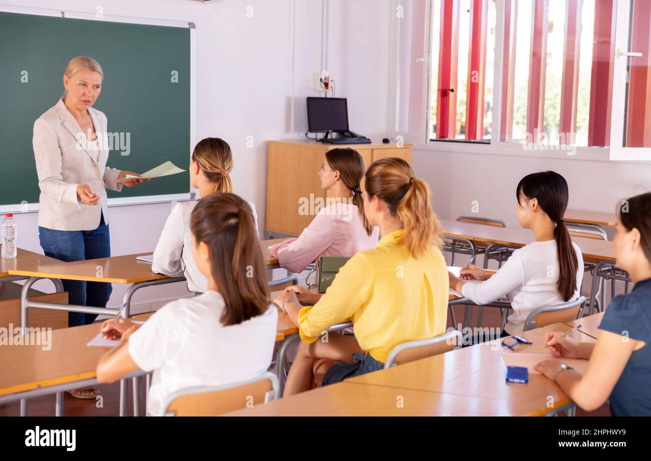 Female teacher lecturing to students Stock Photo - Alamy