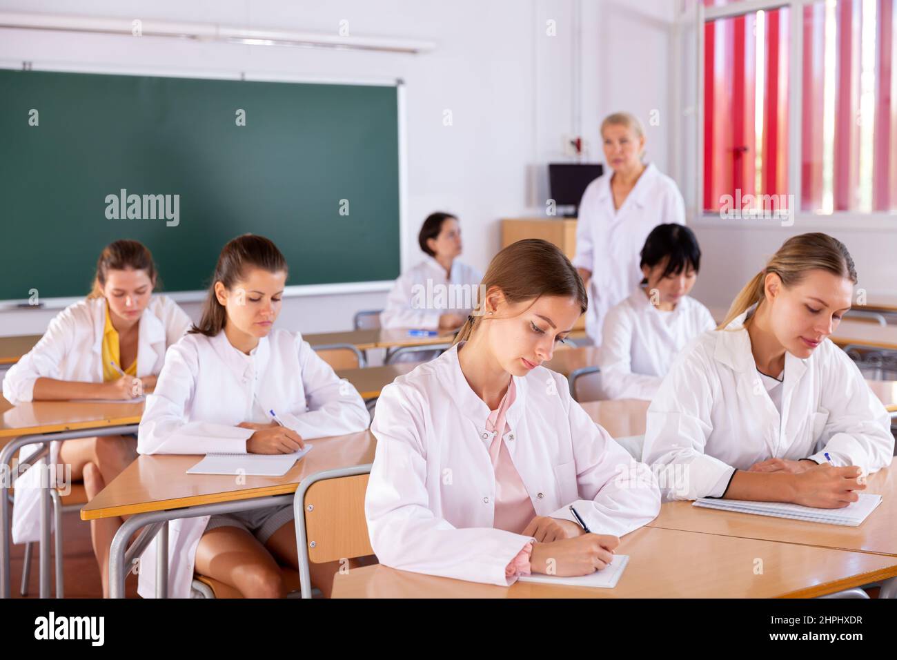 Medical students writing in notepads Stock Photo - Alamy