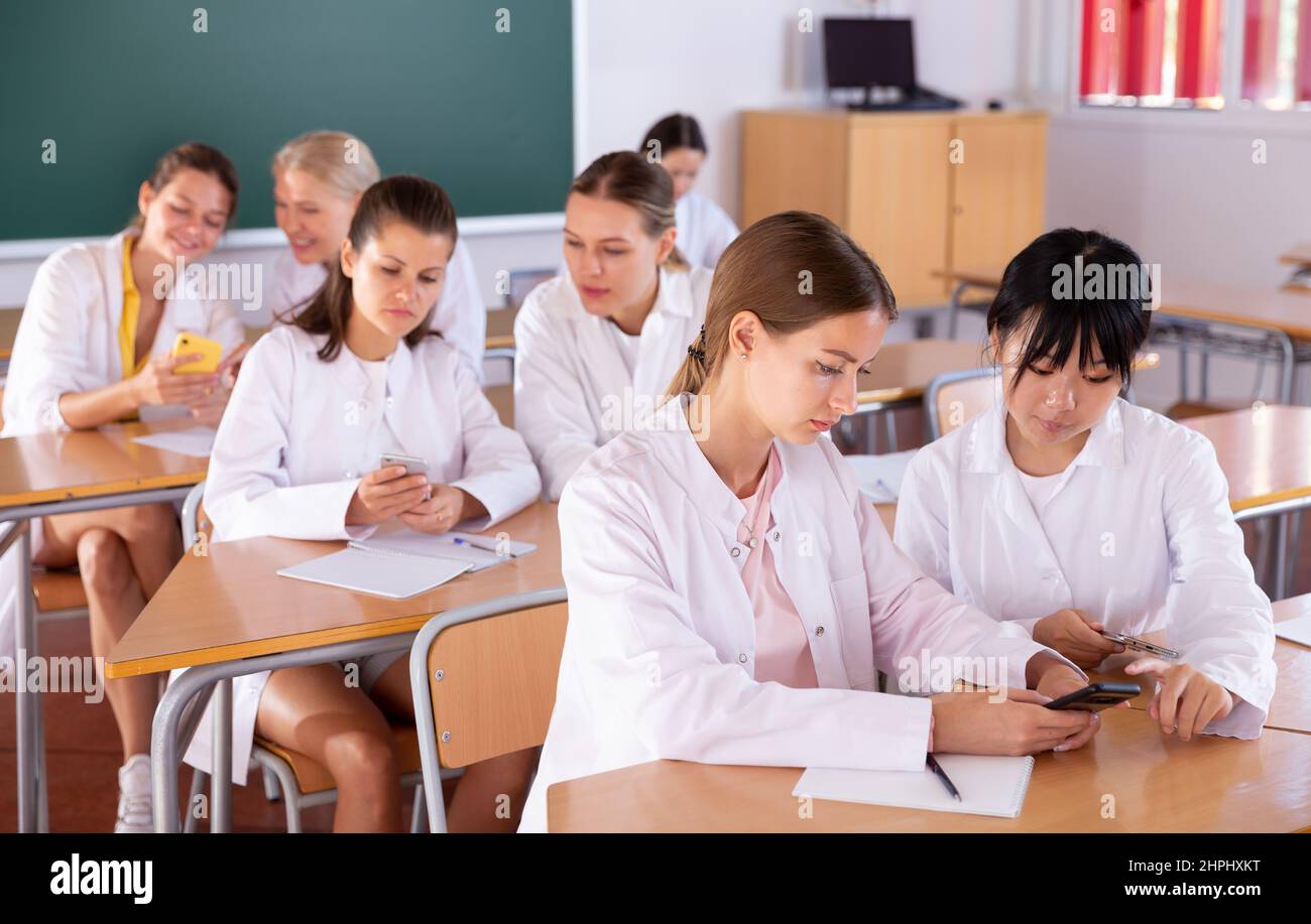 Medical students using phones in common research Stock Photo - Alamy