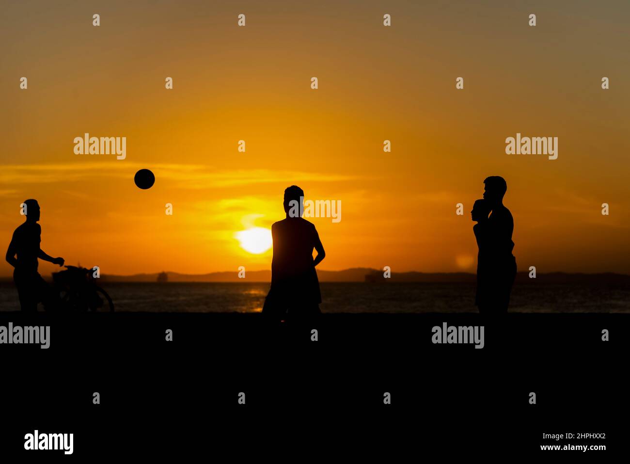 Young people playing beach soccer during sunset at Ribeira beach in ...