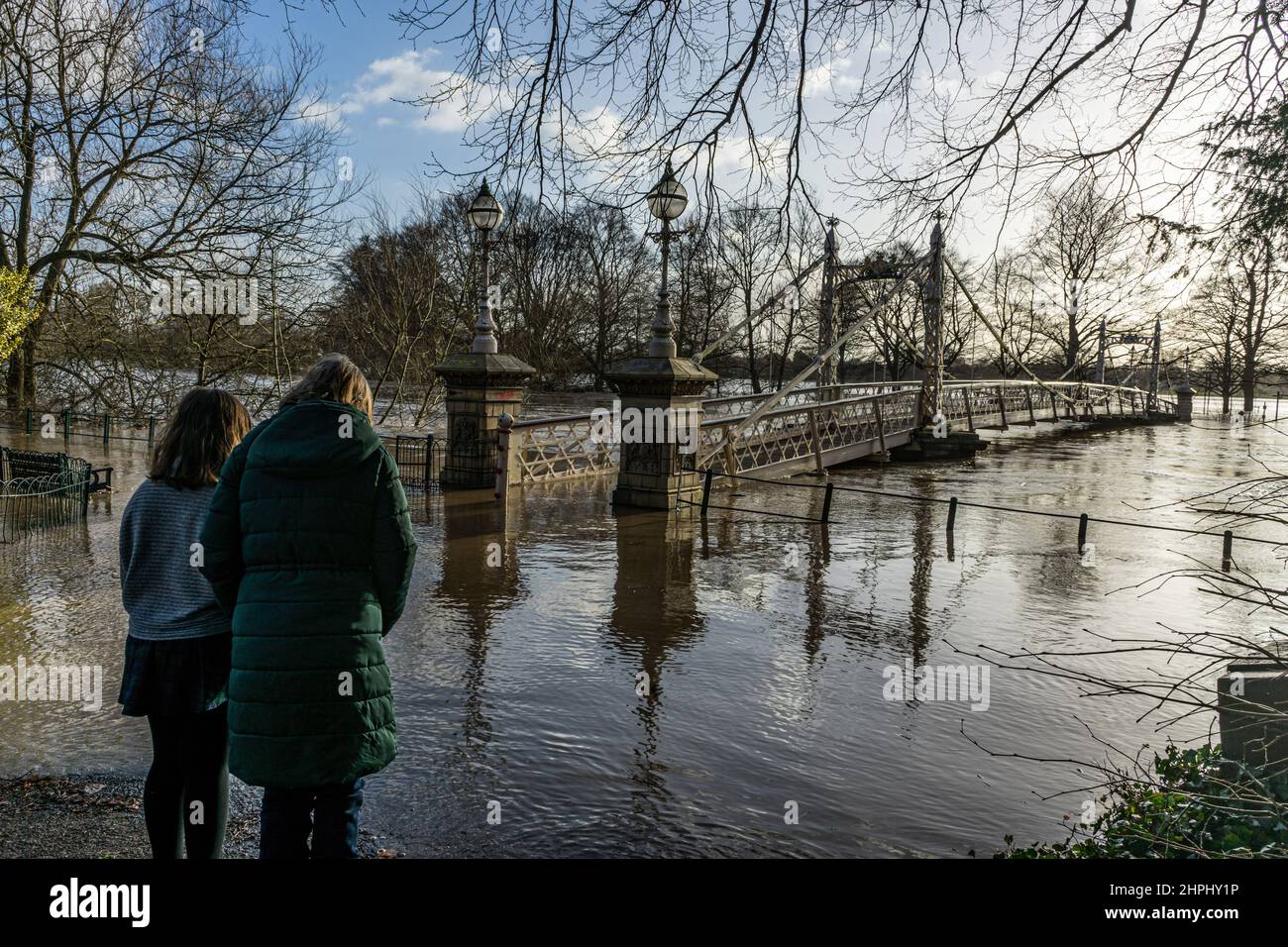 Hereford, UK. 21st Feb, 2021. People watch the floodwater which has ...
