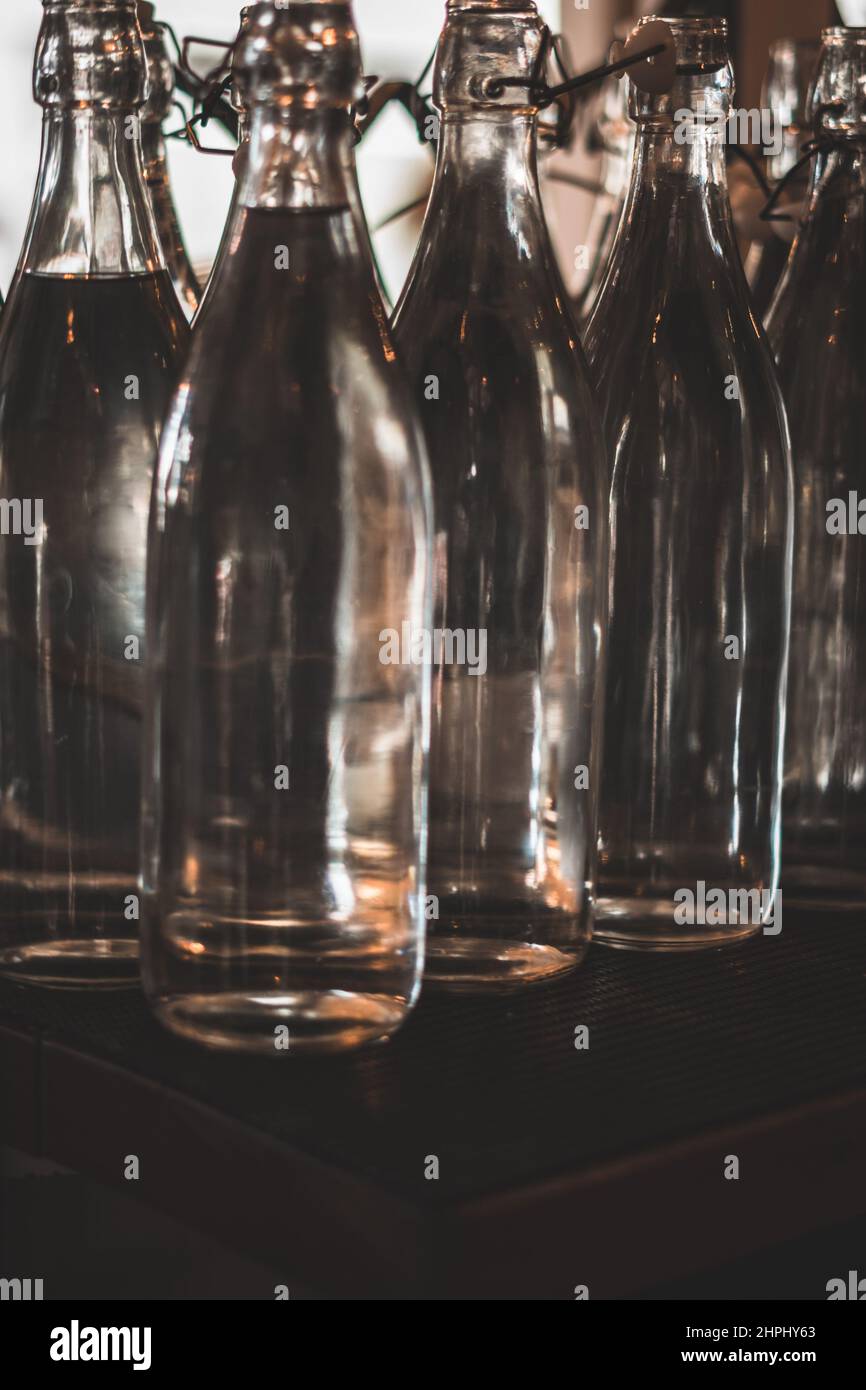 Vertical shot of glass bottles full of water Stock Photo - Alamy