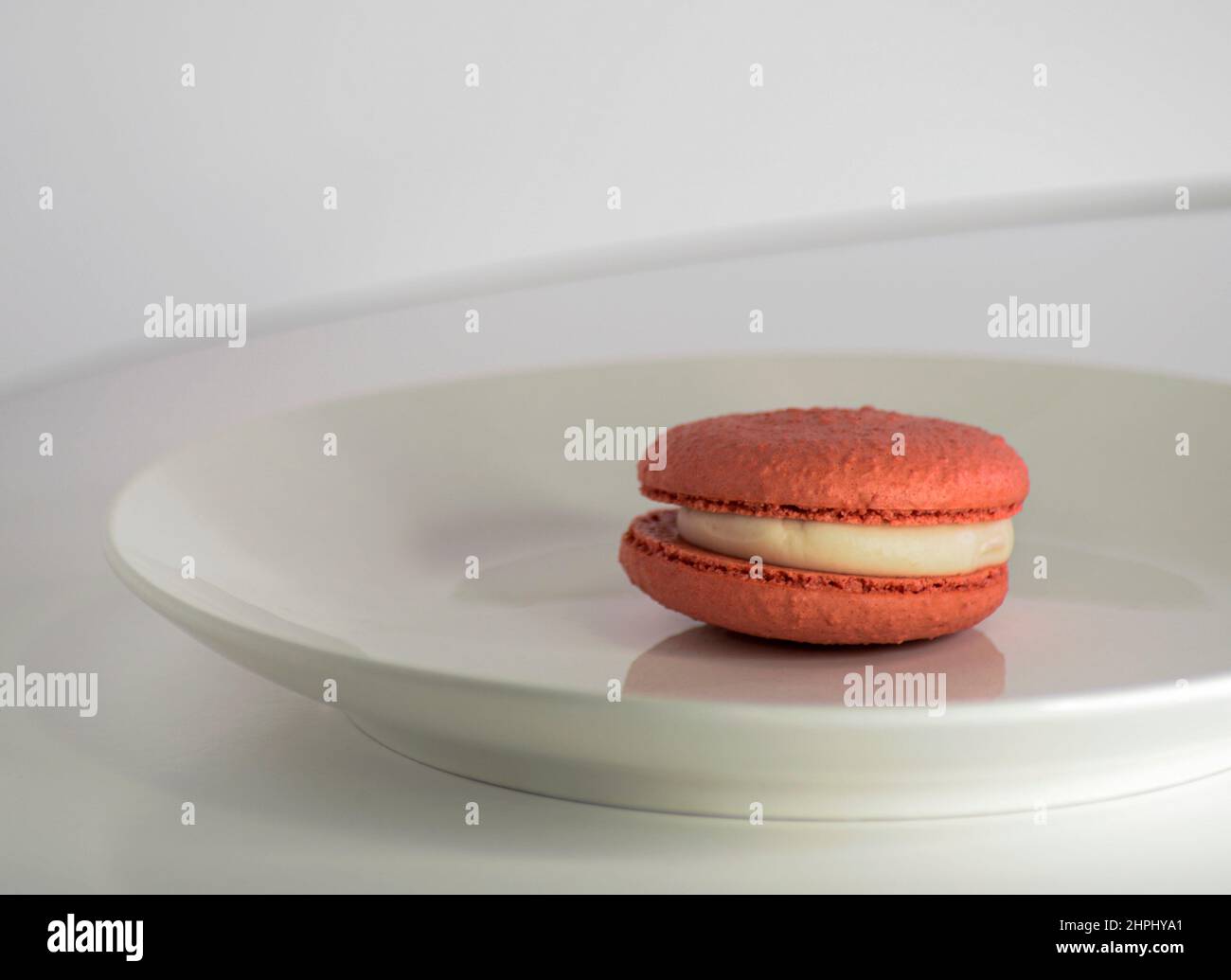 Single red raspberry macaron Stock Photo - Alamy