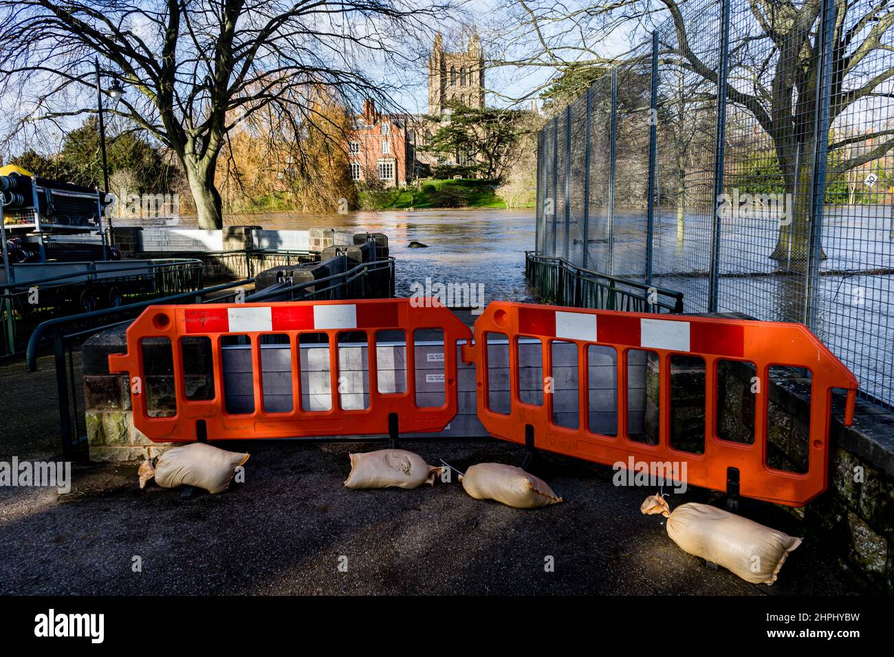 Barriers block an entrance on the banks of the flooded River Wye as ...