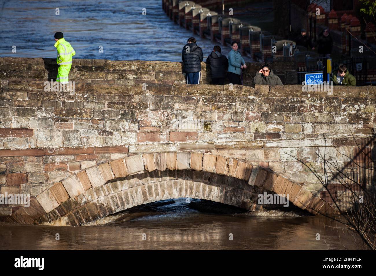 People watch the flood water from the Old Bridge as Storm Franklin ...