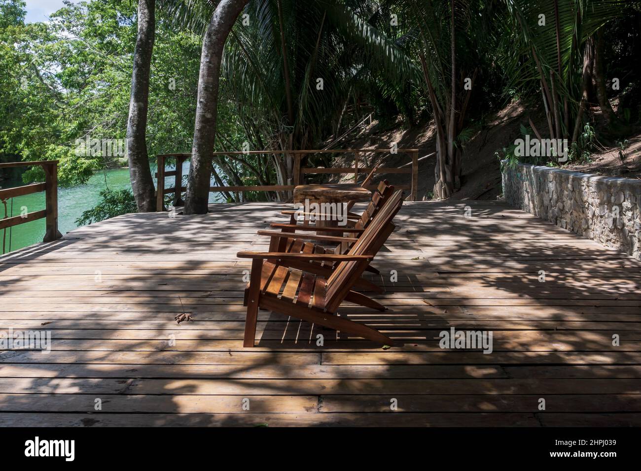 Idyllic river side dock with wooden chairs for swimming surrounded by ...