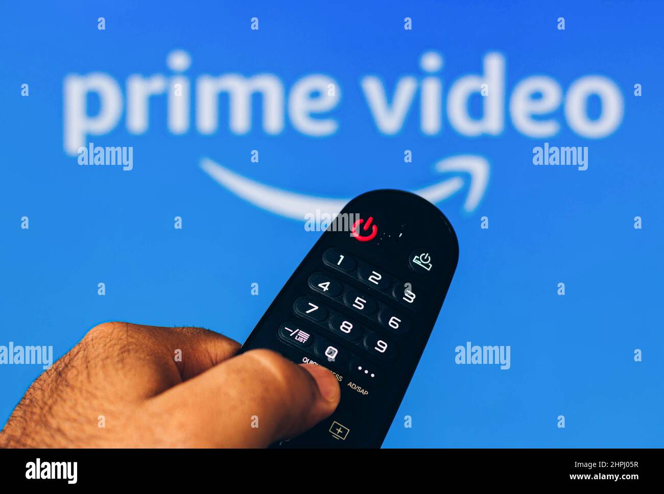In this photo illustration a close-up of a hand holding a TV remote ...
