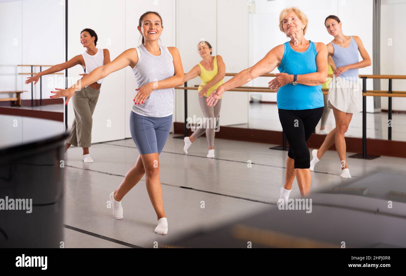 Group of active women practicing energetic dance in a studio Stock ...