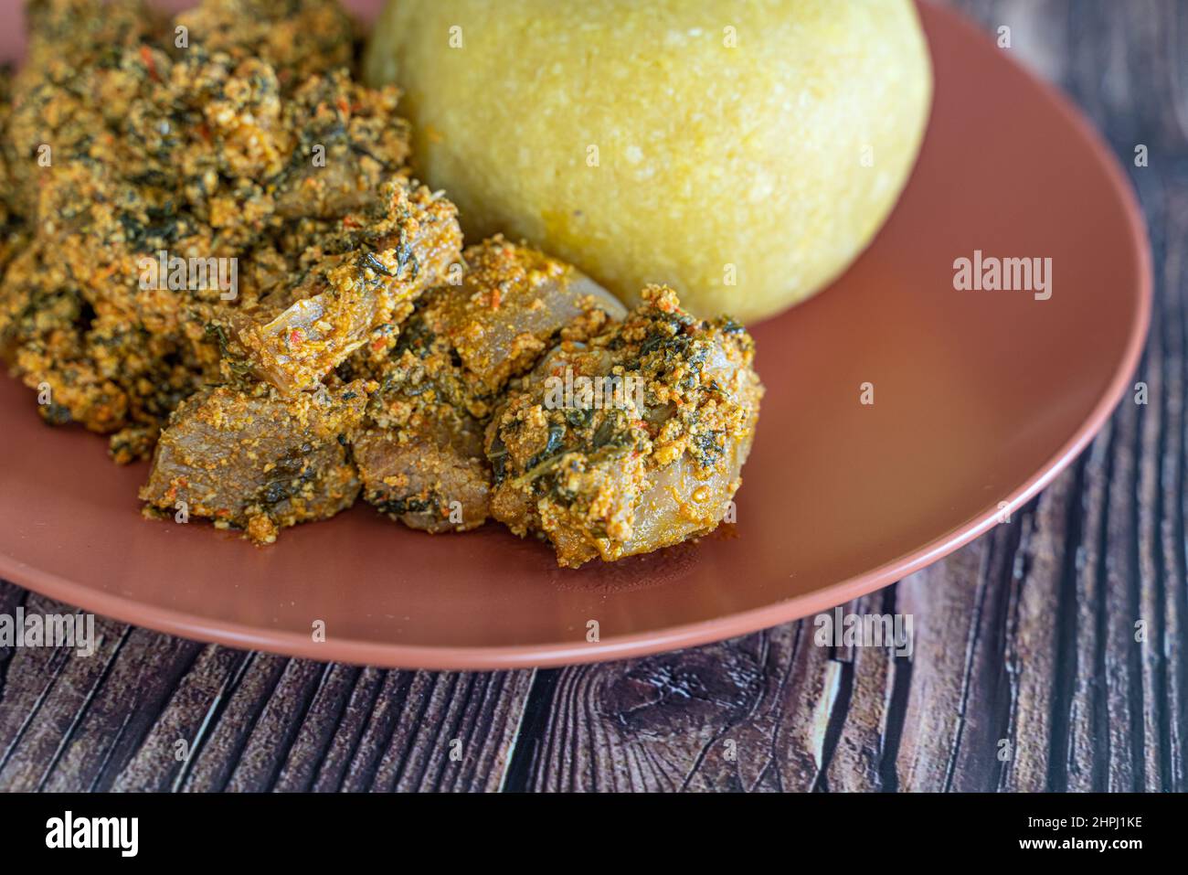 Nigerian Egusi Melon soup with garri eba for lunch Stock Photo - Alamy