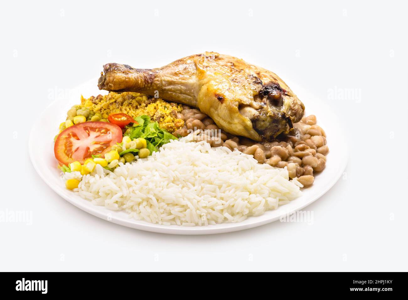 rice and beans dish, large roasted chicken thigh, chopped tomato salad ...