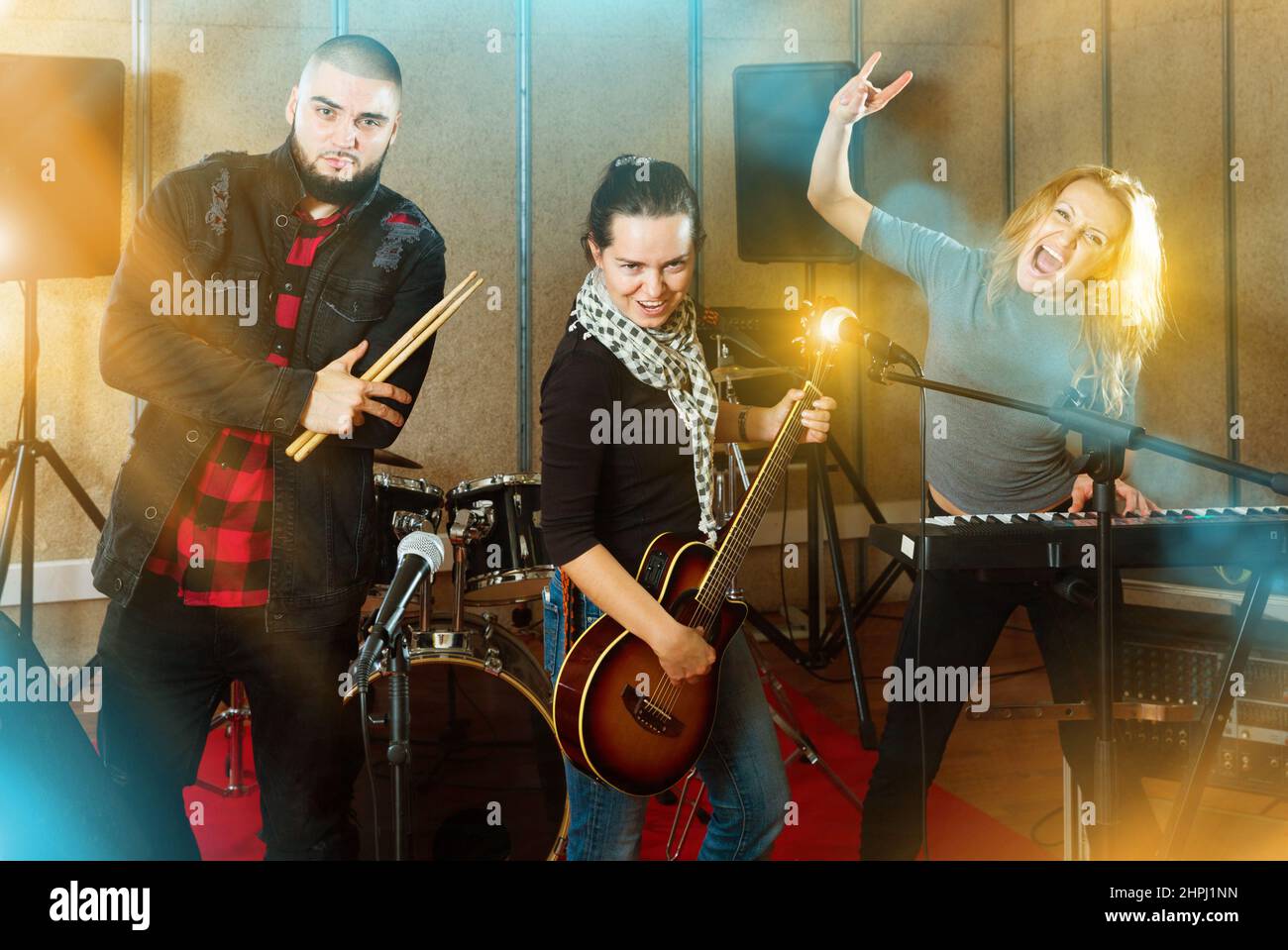 Three bandmates posing together with musical instruments in rehe Stock ...