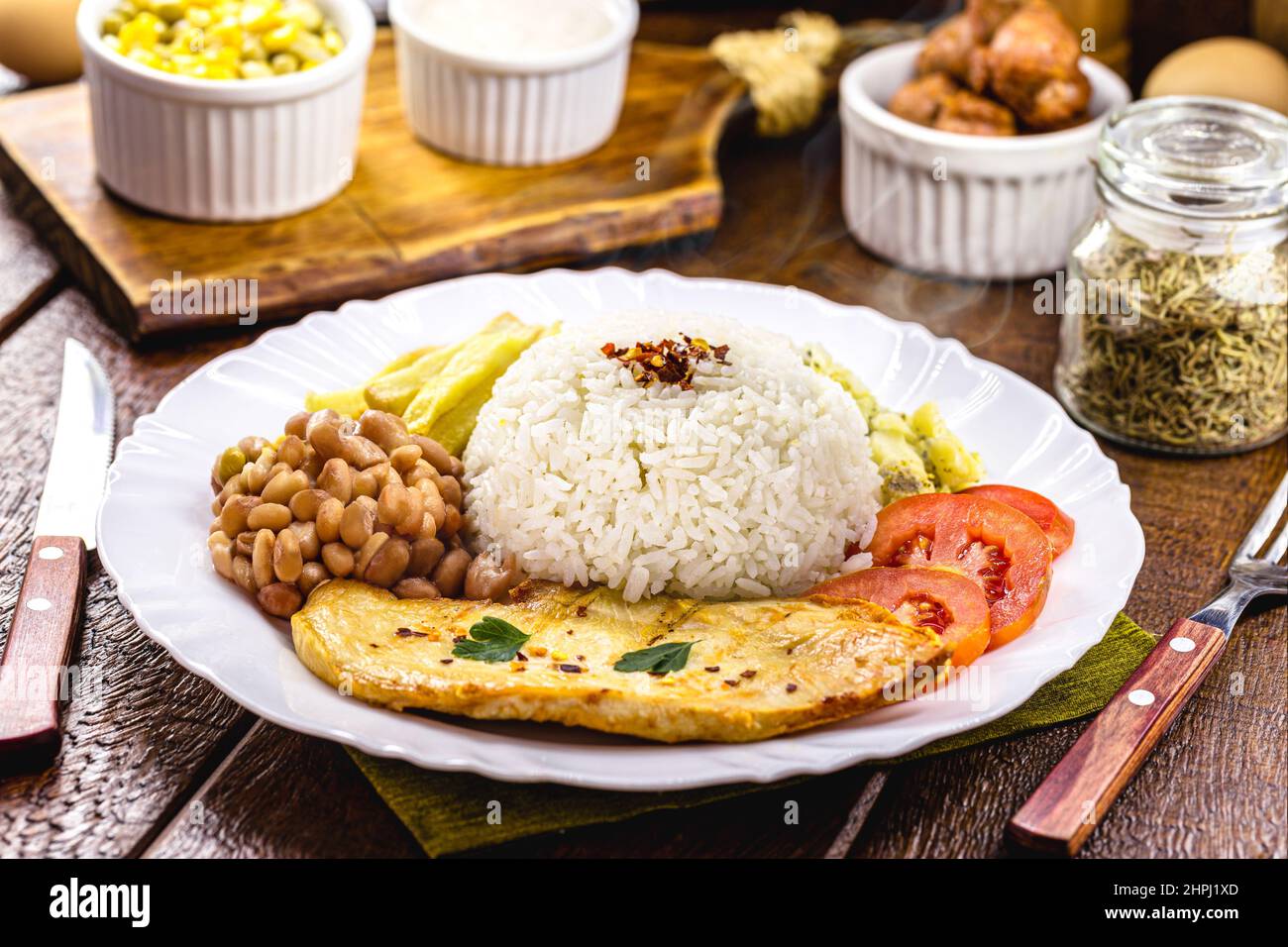 typical brazilian lunch rice and beans, grilled chicken fillet and ...
