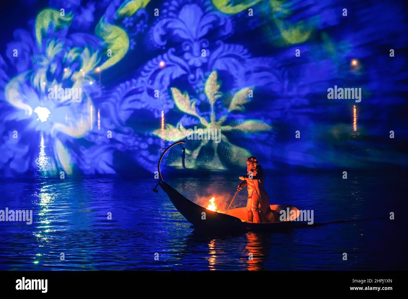 A man is seen rowing a boat with a fire inside the boat during the ...