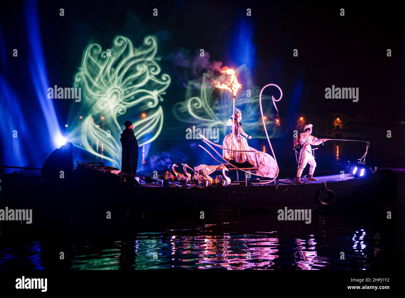 Three performers seen performing on a boat during the Venice Carnival ...